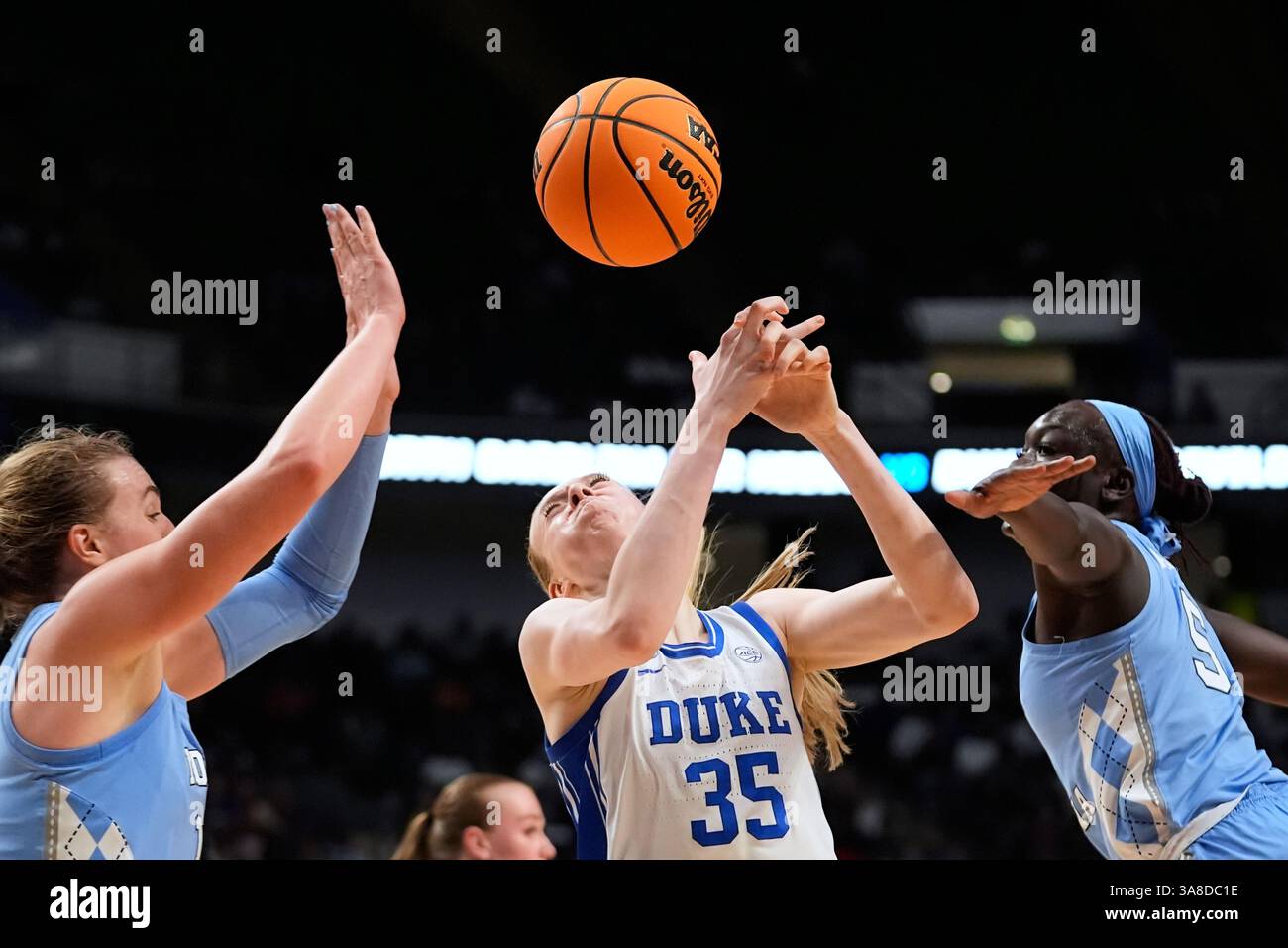 Duke forward Toby Fournier (35) battles for the ball between North ...