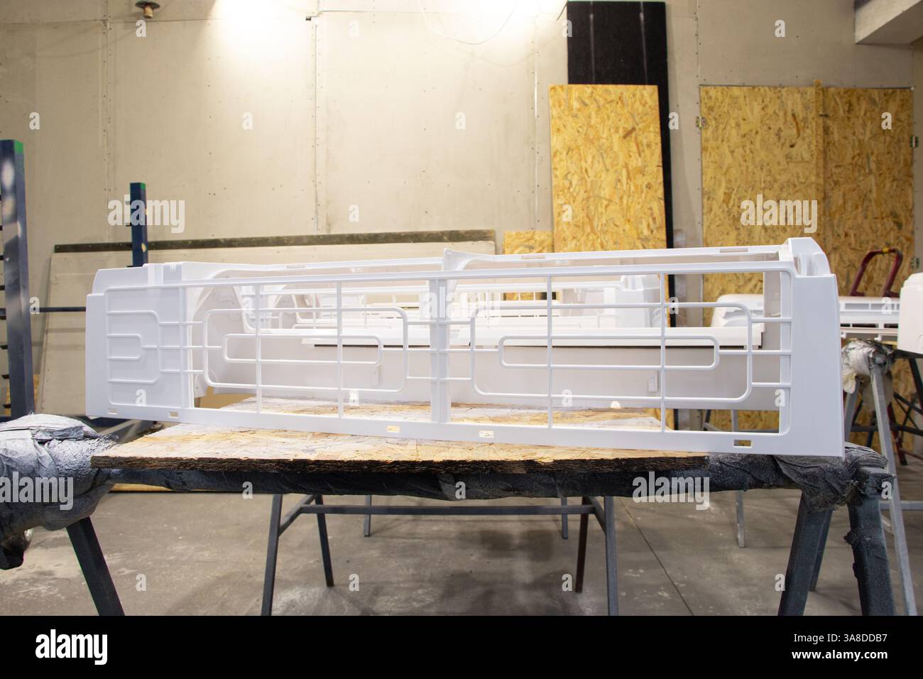 Paint shop, where air conditioner housings are laid out on tables for ...