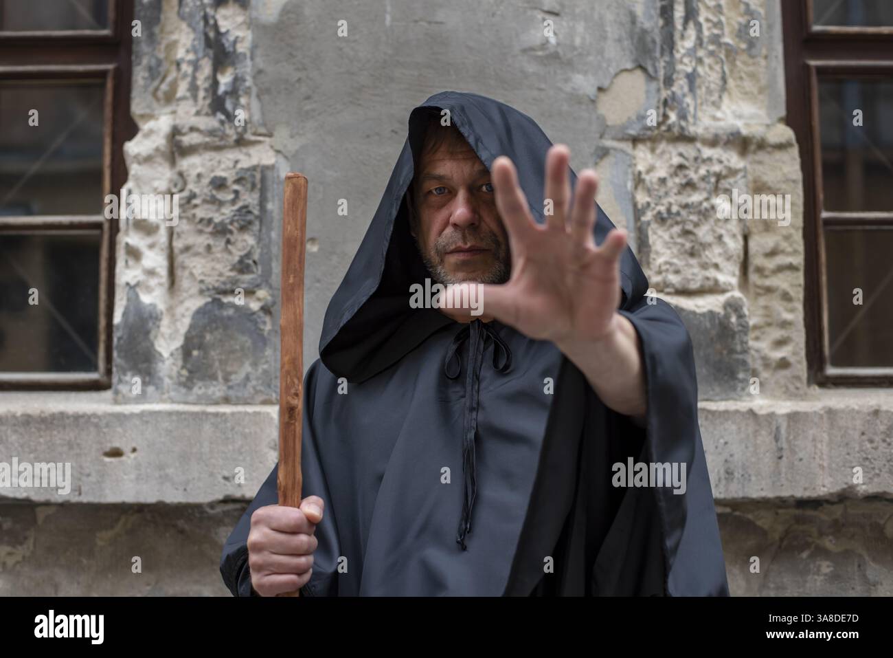A hermit monk in a black hooded cloak symbolising wisdom and sorcery ...