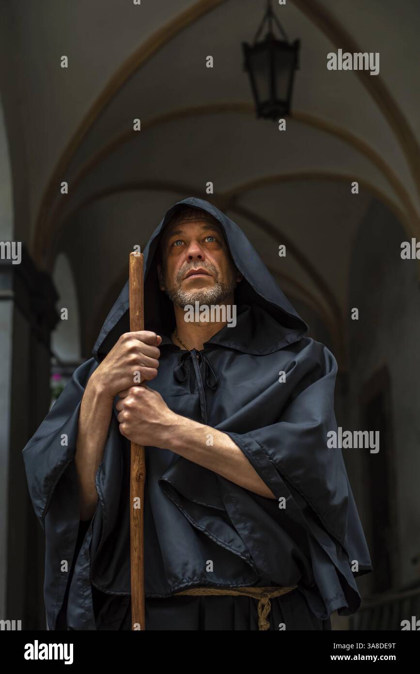 Historical image of a monk in period costume with hood Stock Photo - Alamy