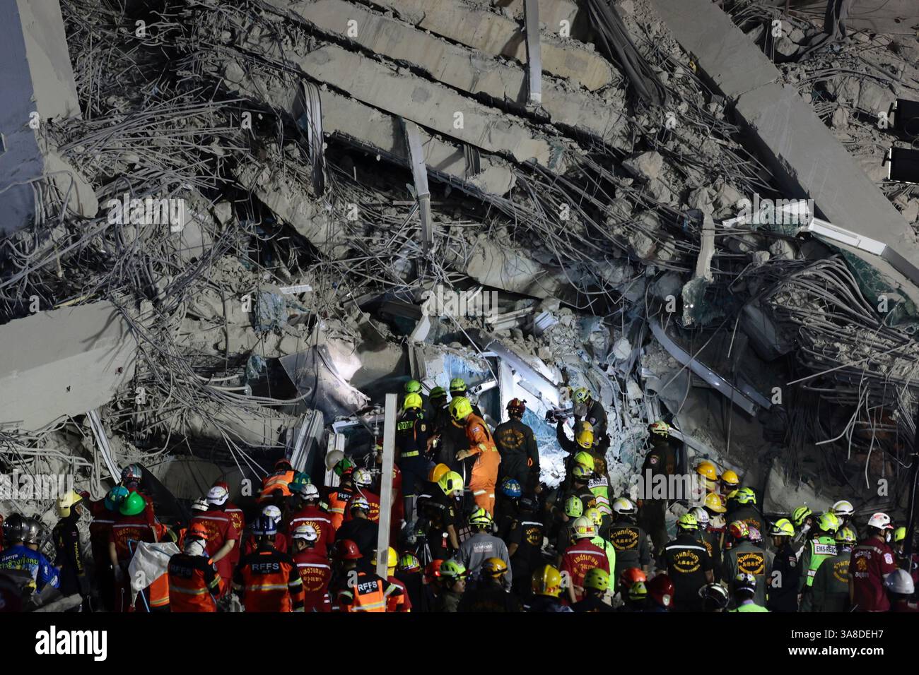 Rescuers work at the site of a high-rise building under construction ...