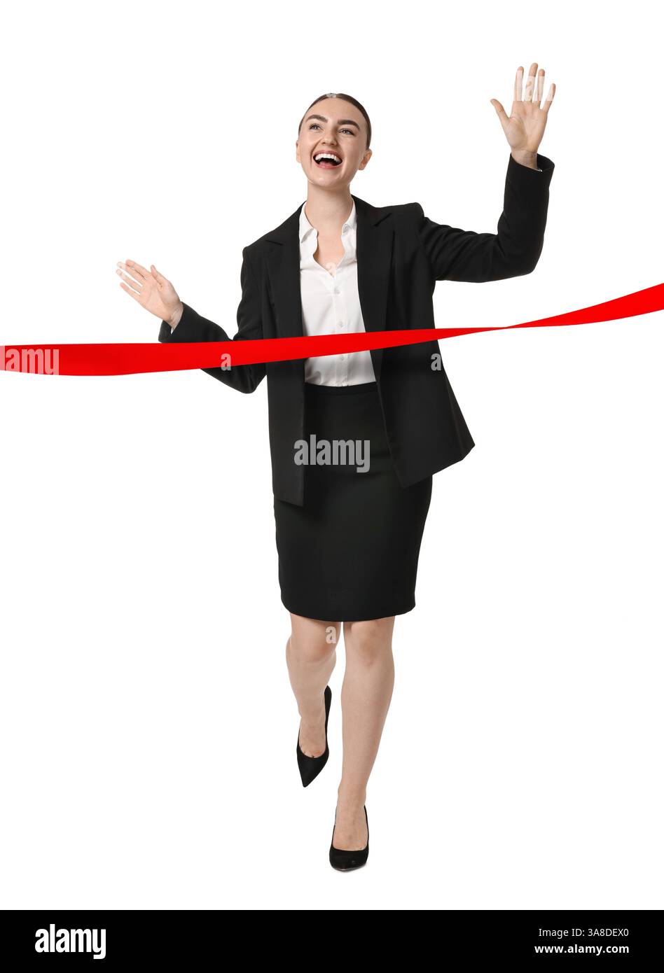 Happy businesswoman crossing red finish line ribbon on white background ...