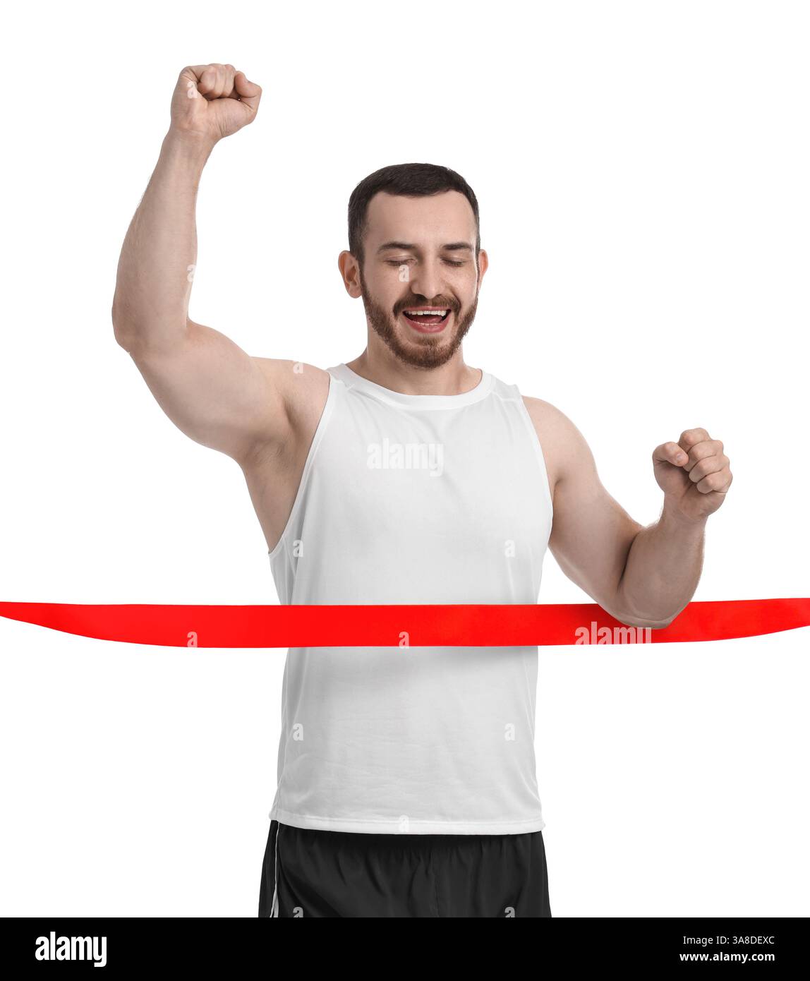 Happy sportsman crossing red finish line ribbon on white background ...