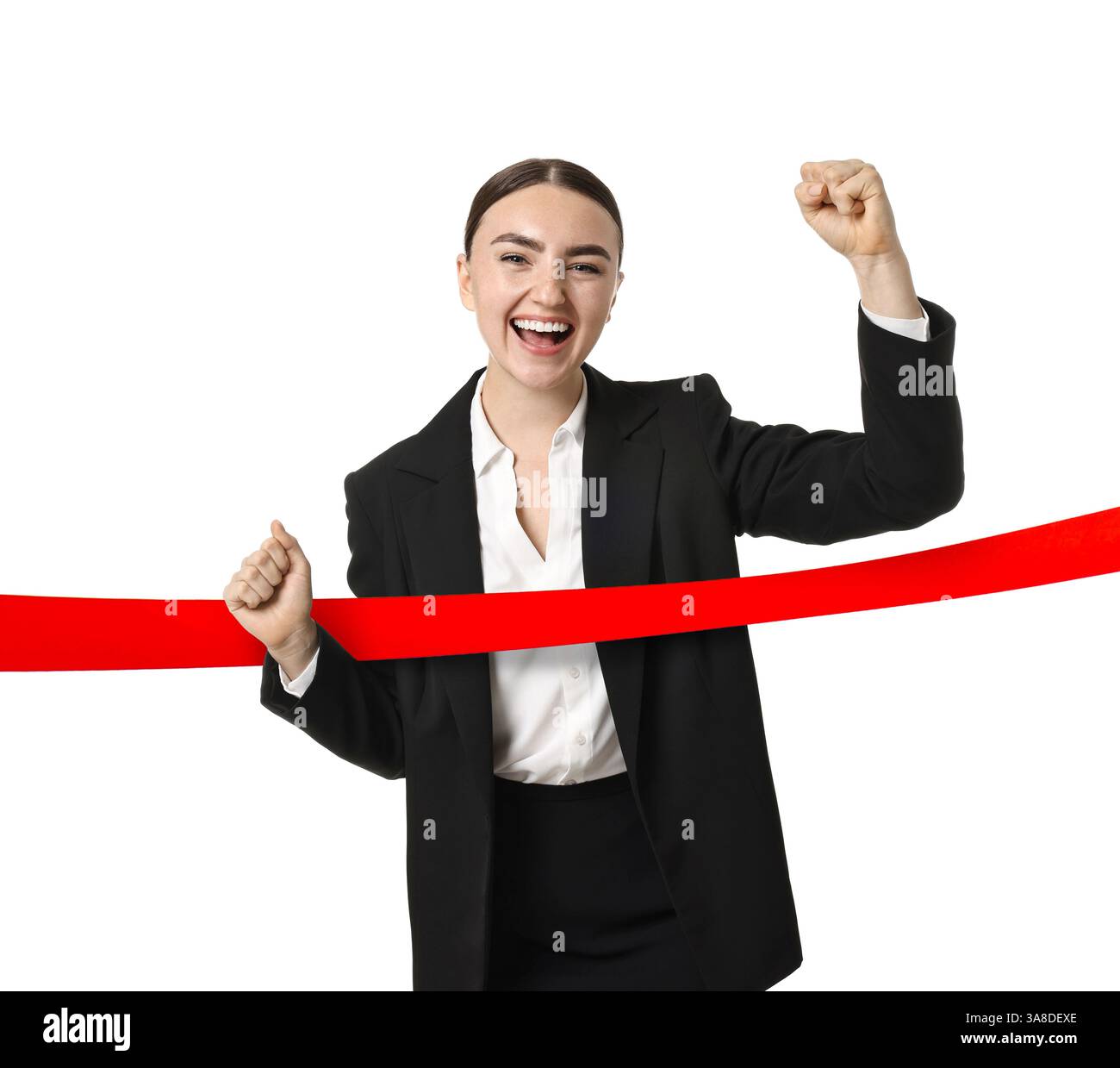 Happy businesswoman crossing red finish line ribbon on white background ...