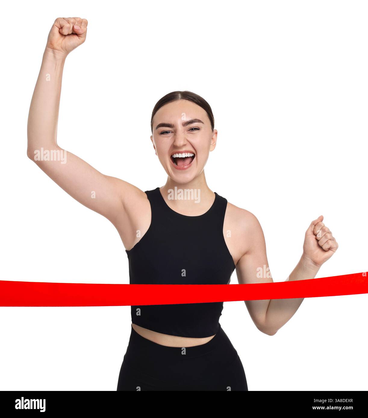 Happy sportswoman crossing red finish line ribbon on white background ...