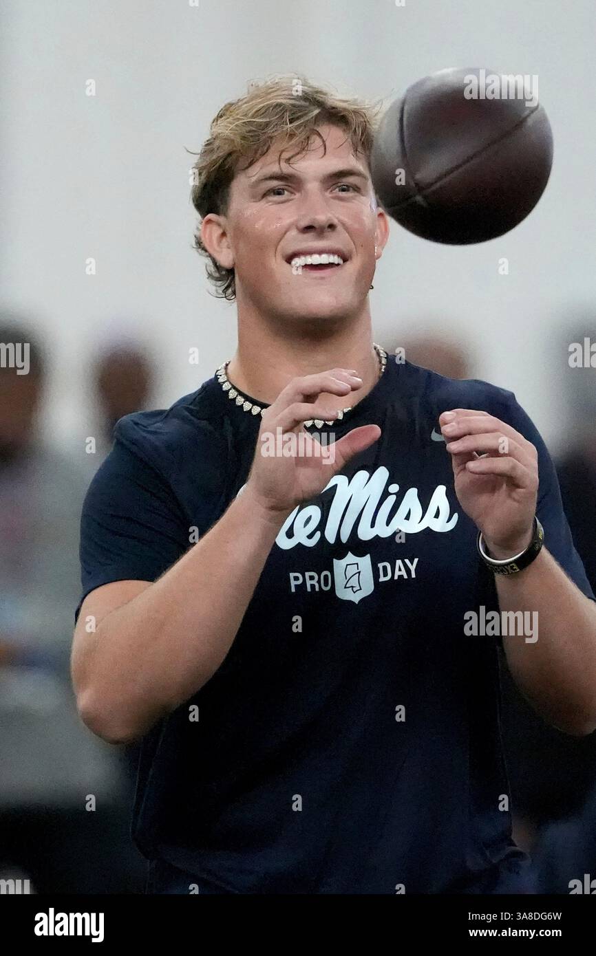 Mississippi quarterback Jaxson Dart catches a ball during an offensive passing drill at the ...