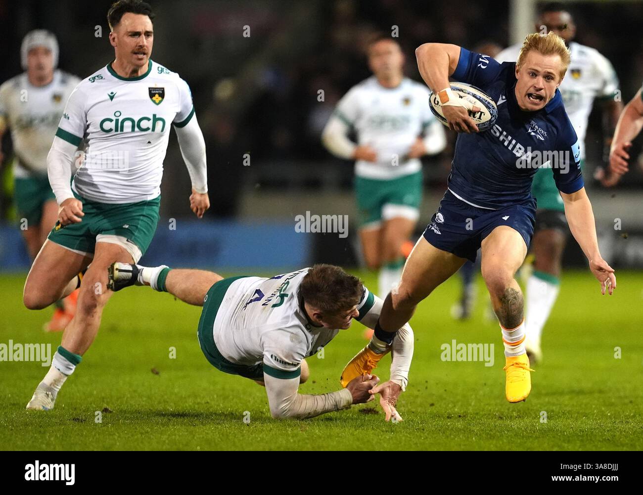 Sale Sharks' Arron Reed is tackled by Northampton Saints' Tommy Freeman ...