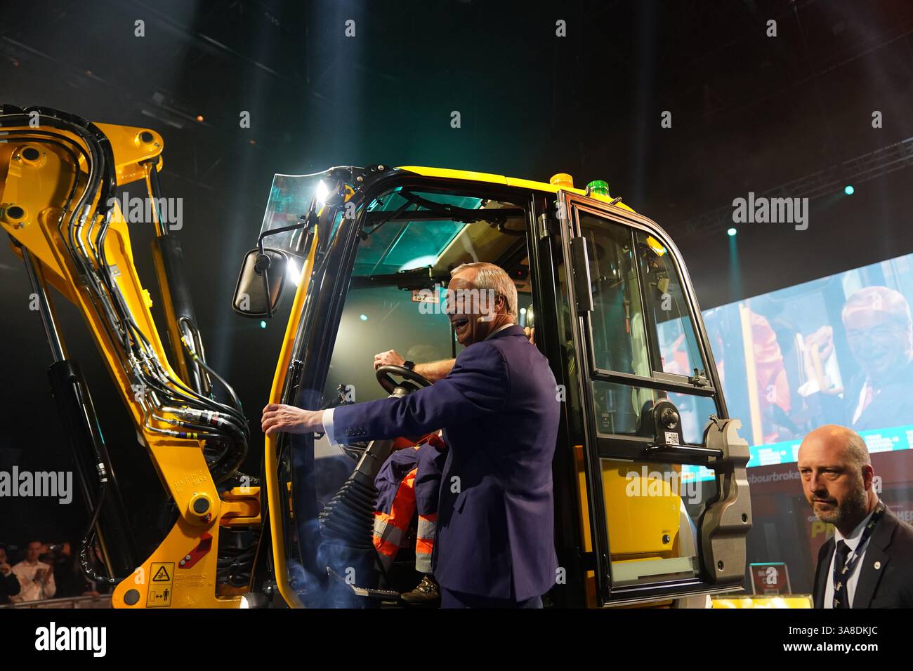 Reform UK leader Nigel Farage arrives on a JCB digger during the Reform ...