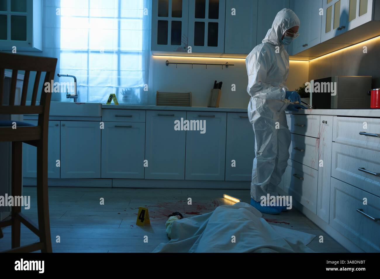 Forensic expert taking fingerprints with brush from countertop and dead ...