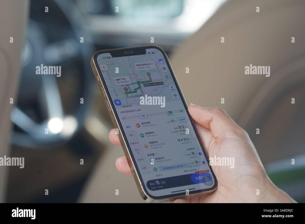 China. 27th Mar, 2025. In this photo illustration, A woman browses AMAP ...