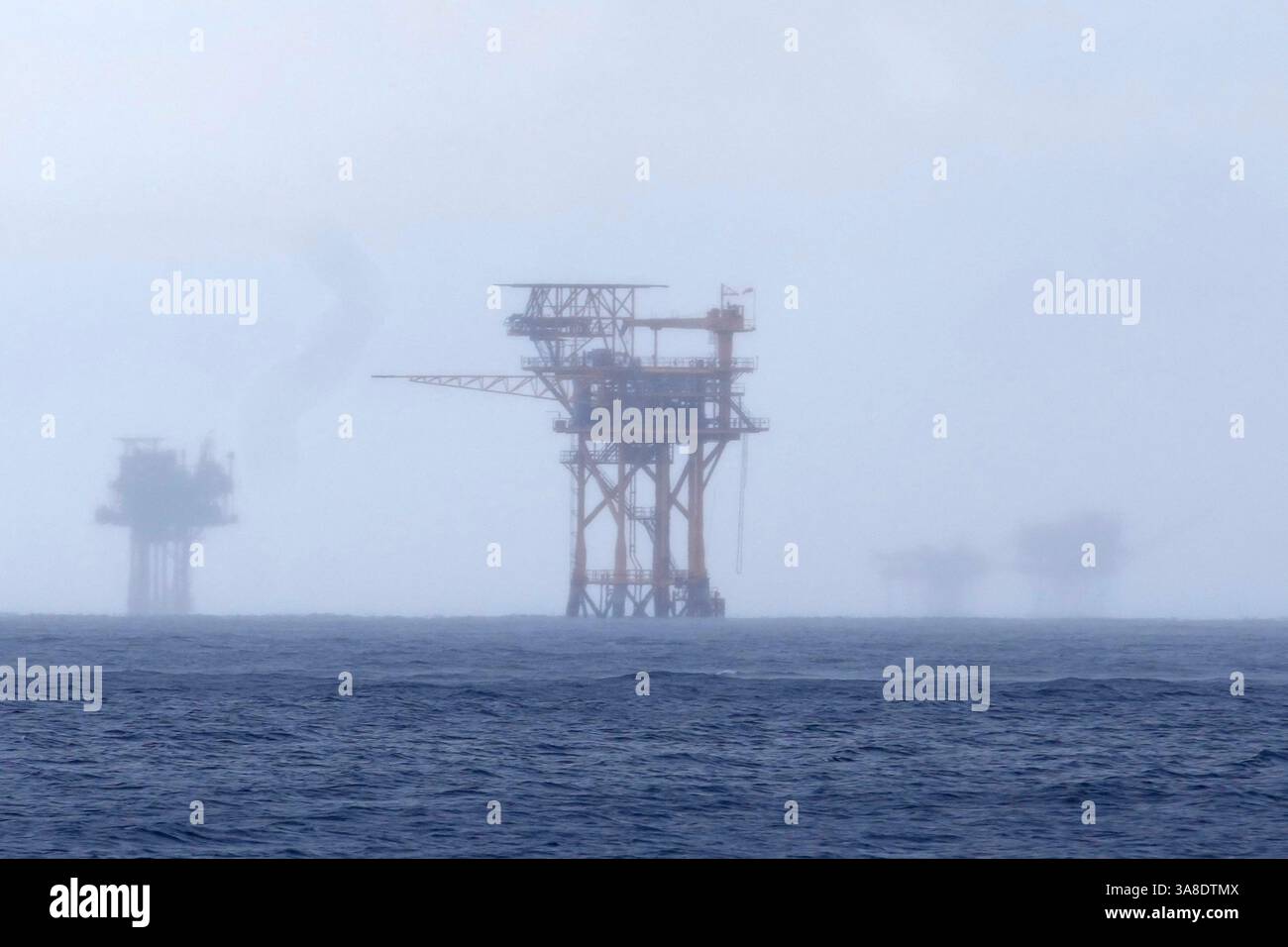 FILE - Oil platforms are visible through the haze near the Flower ...