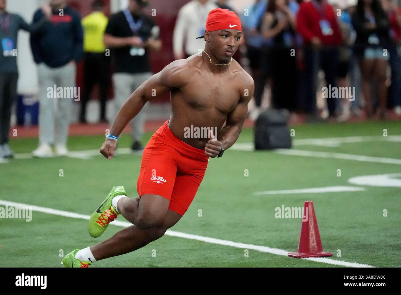 Mississippi wide receiver Josh Aka leans into his run around cones at ...