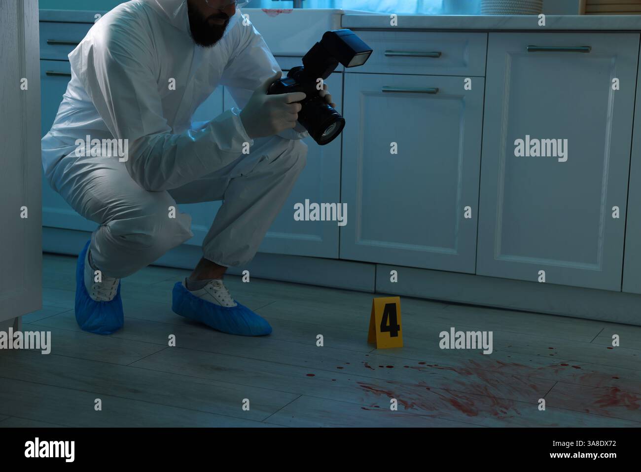 Forensic expert with camera working at crime scene indoors, closeup ...