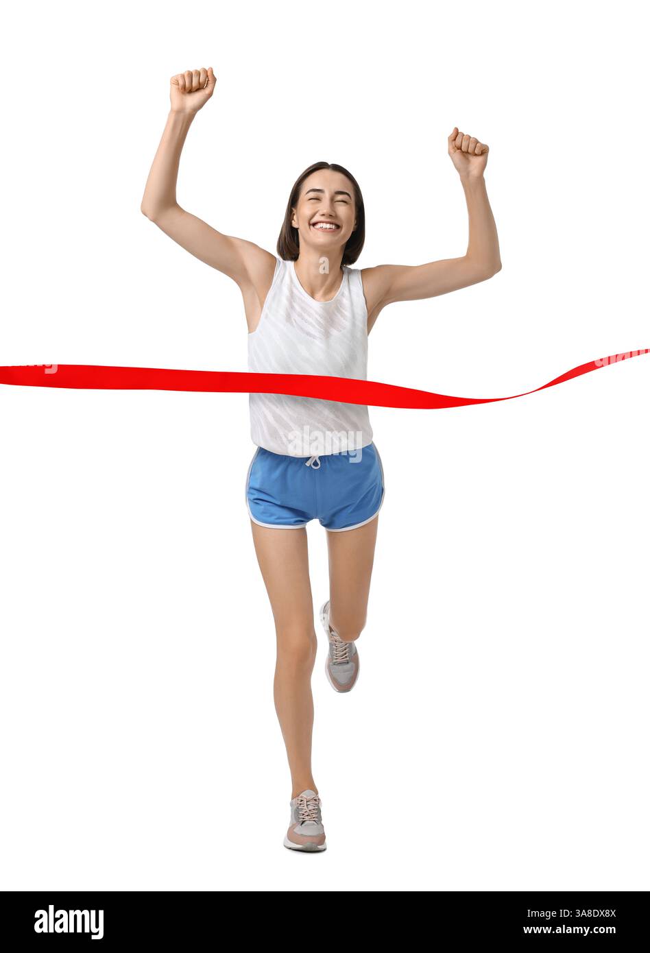 Happy sportswoman crossing red finish line ribbon on white background ...