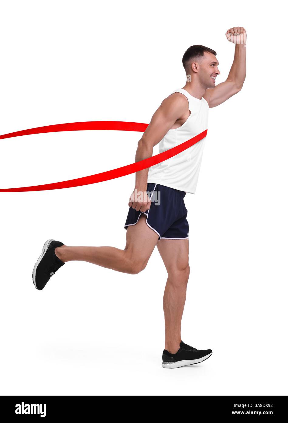 Happy sportsman crossing red finish line ribbon on white background ...