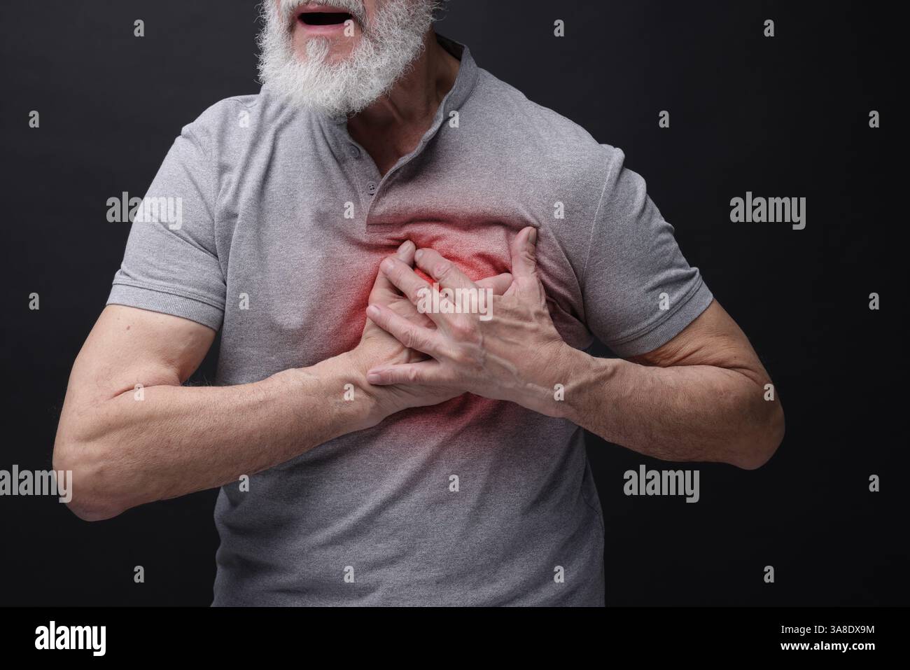 Heart attack. Senior man suffering from pain in chest on black ...
