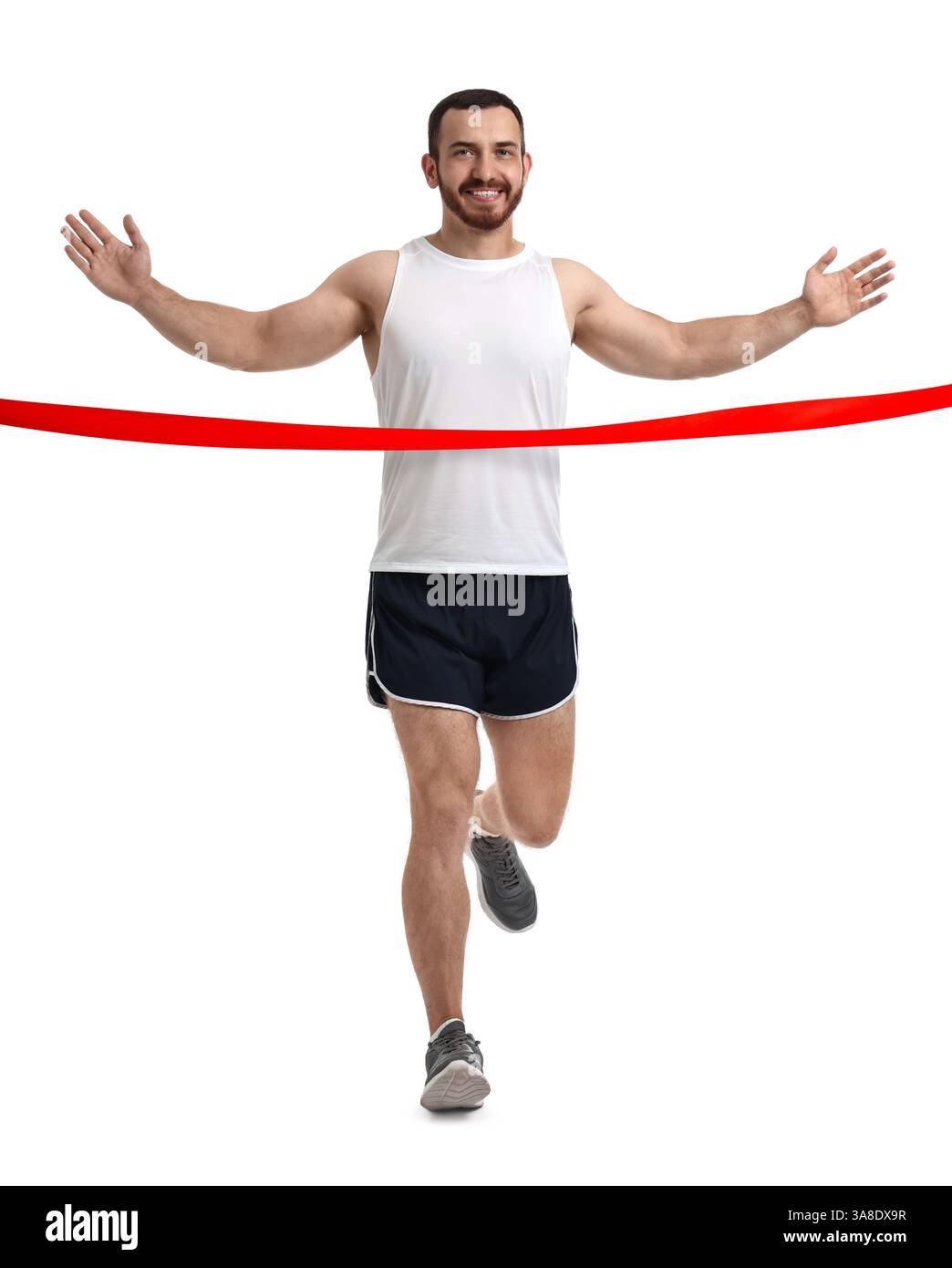 Happy sportsman crossing red finish line ribbon on white background ...