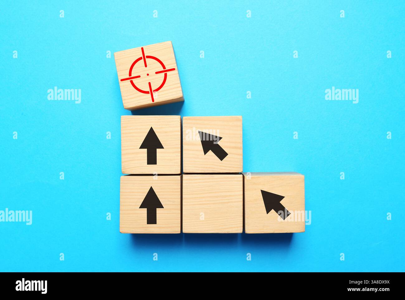 Targeting. Cubes with arrows pointing at one with bullseye on light blue background, top view ...