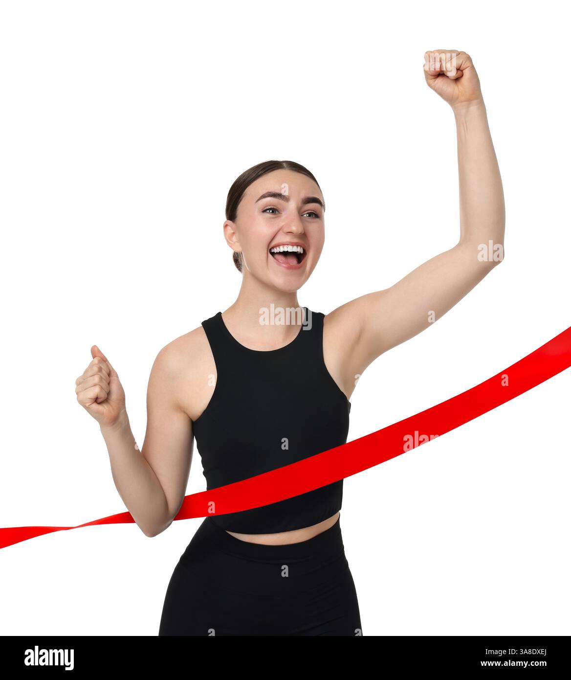 Happy sportswoman crossing red finish line ribbon on white background ...