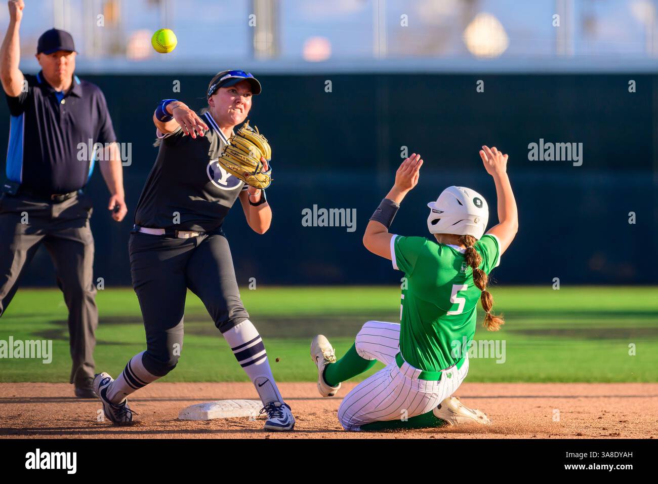 BYU shortstop Hailey Morrow, left, makes the out at second base and ...