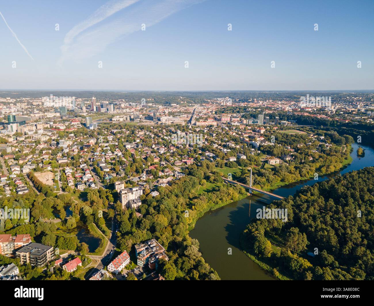 Aerial panoramic view of a city with a river and green landscapes ...