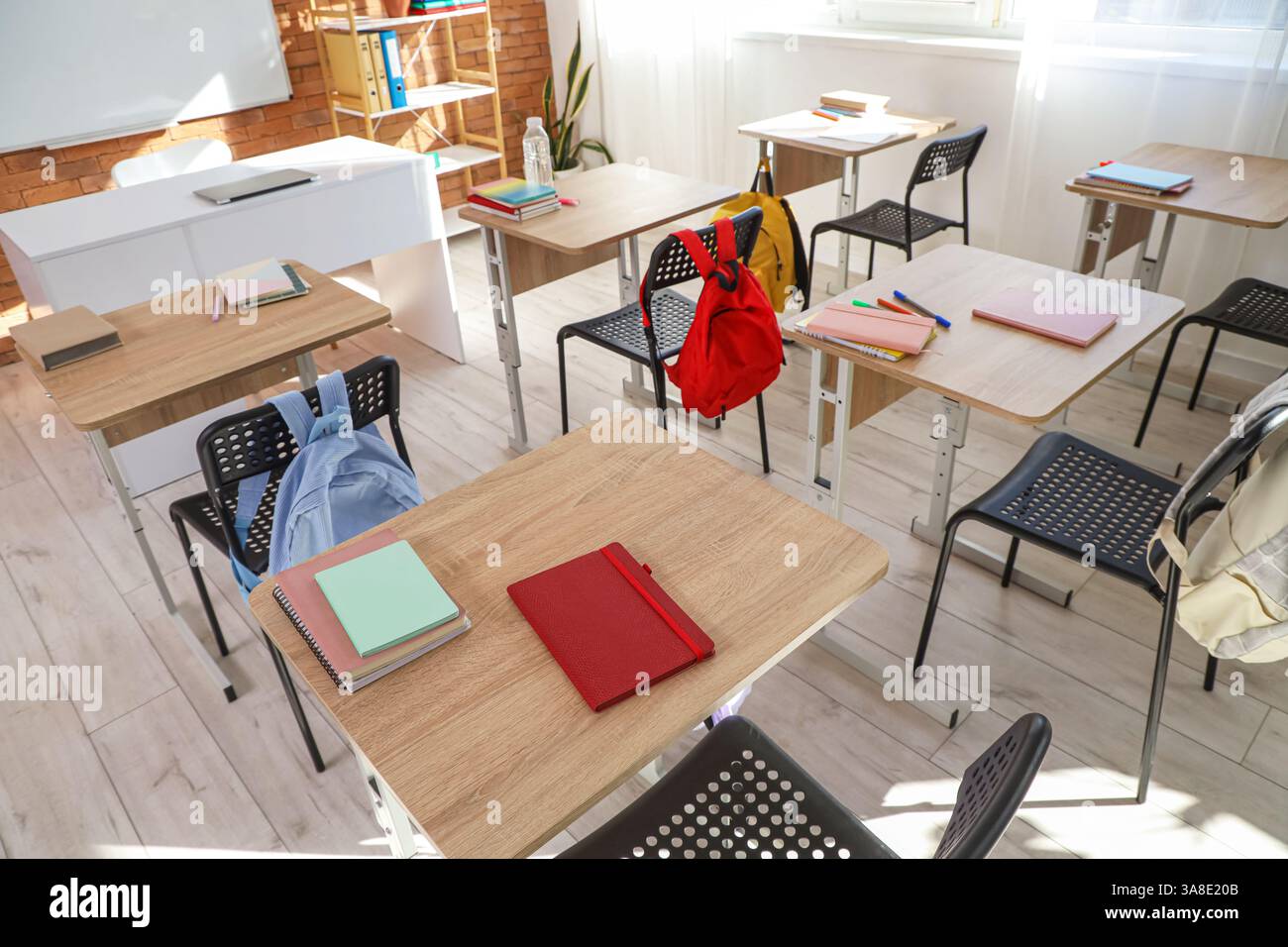 Interior of empty classroom with desks and backpacks Stock Photo - Alamy