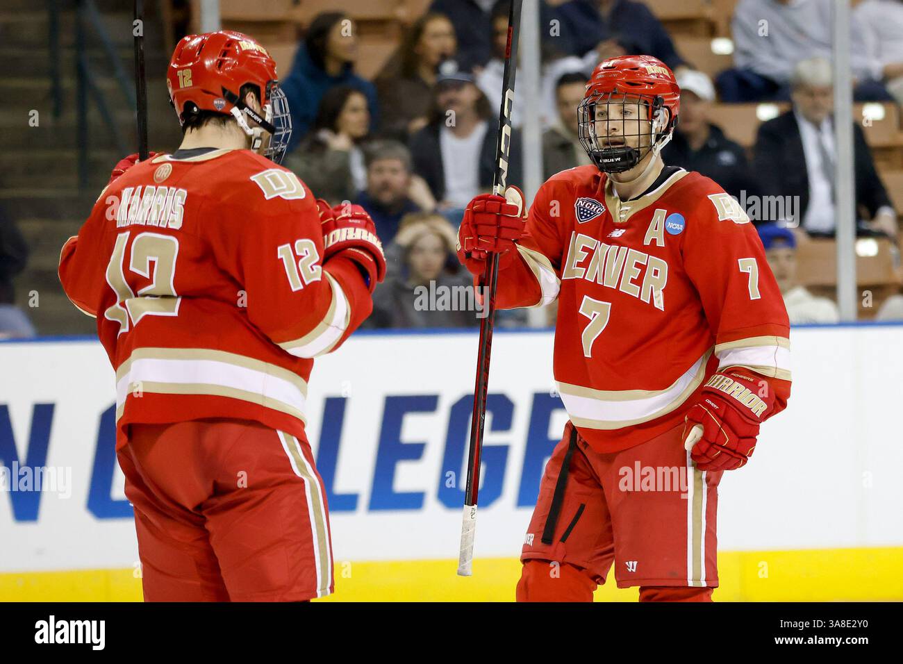 Denver forward Sam Harris (12) celebrates with forward Aidan Thompson ...