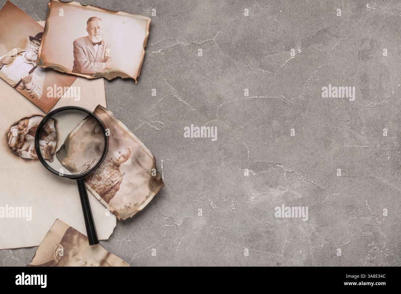 Old photos of relatives with magnifier on grunge background with space ...