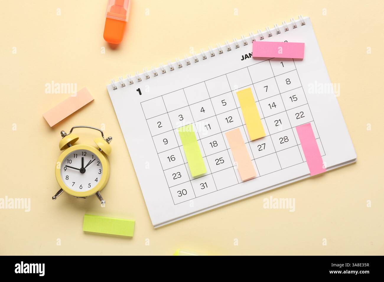 Calendar with alarm clock and stickers on yellow background Stock Photo ...