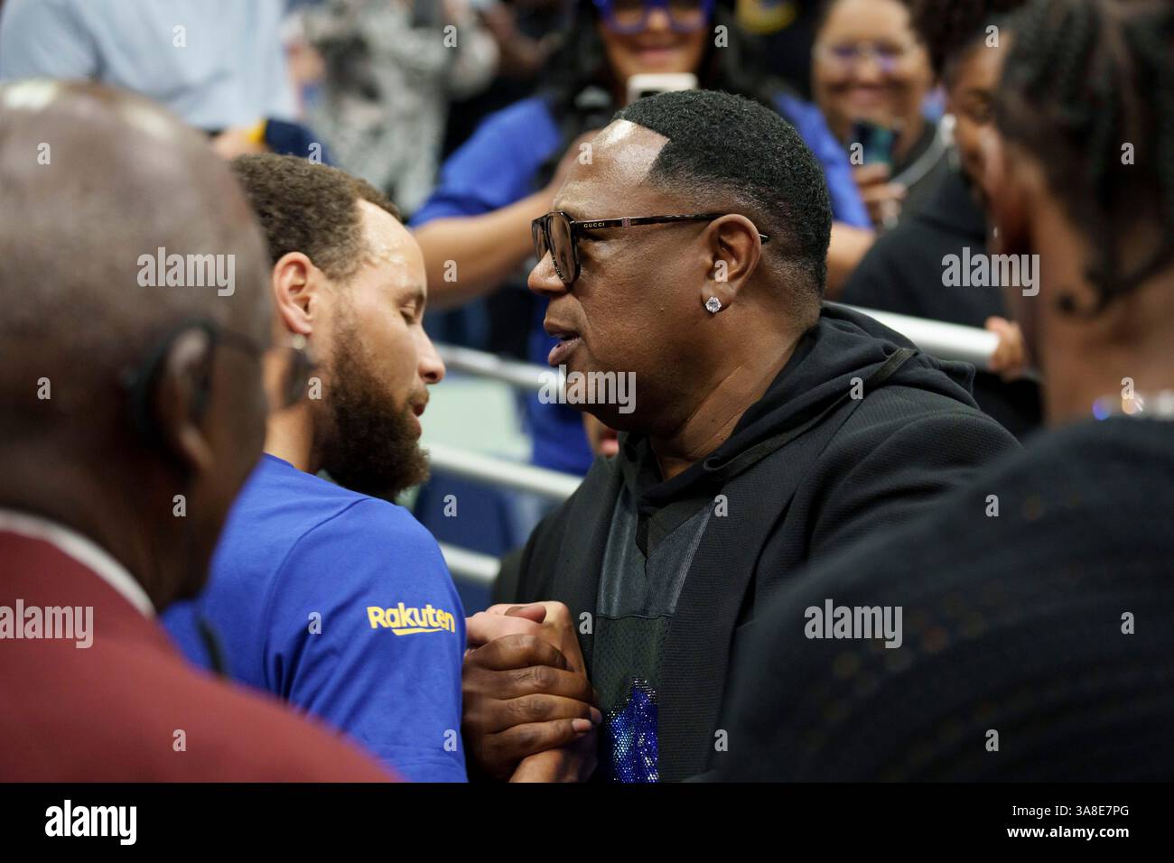Golden State Warriors guard Stephen Curry, left, greets rapper Percy ...
