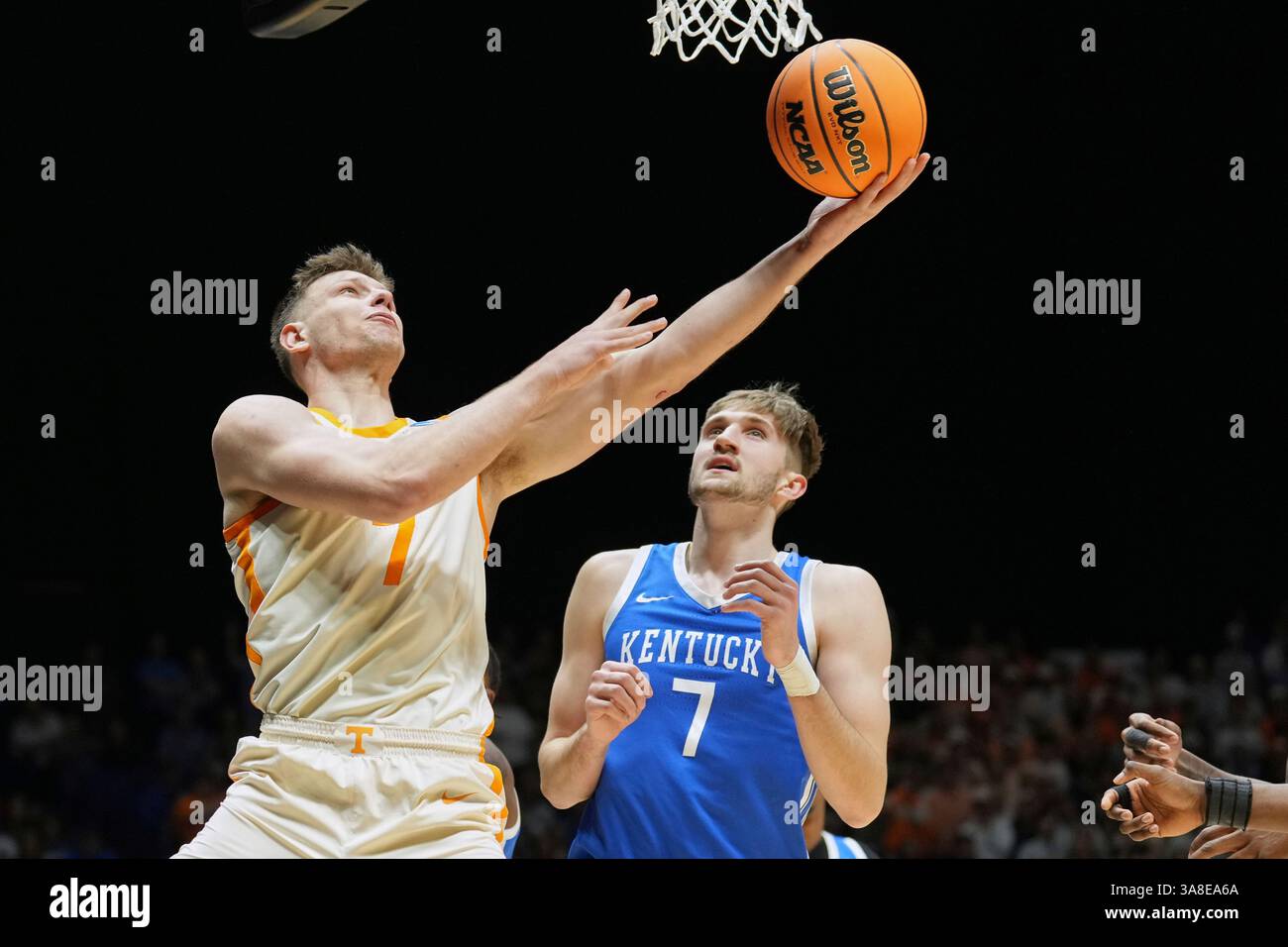 Tennessee's Igor Milicic Jr., left, heads to the basket as Kentucky's ...
