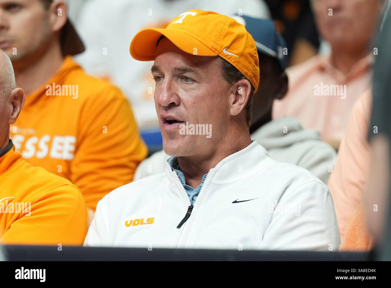 Peyton Manning watches during the first half in the Sweet 16 of the ...