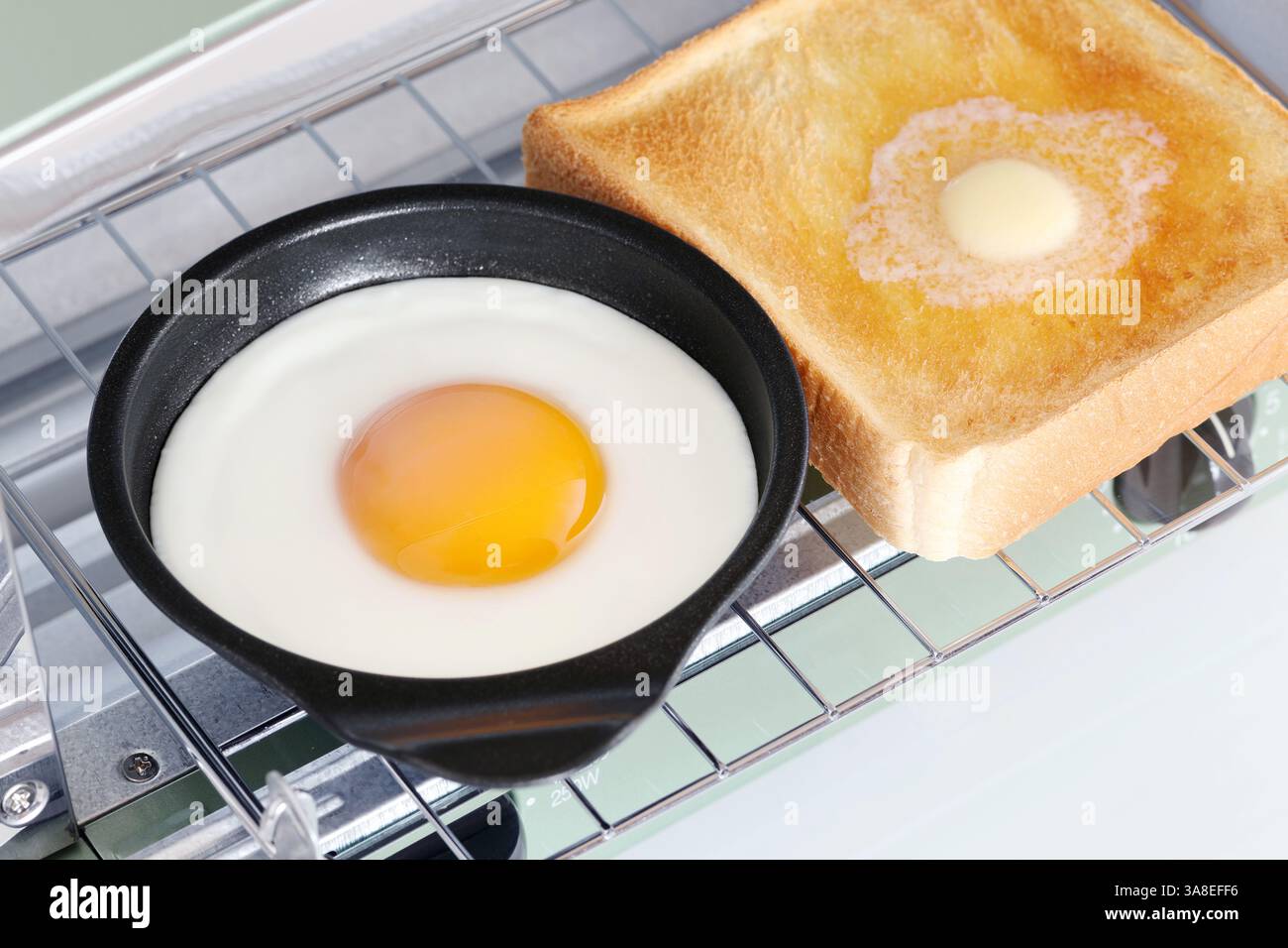 close up of fried egg and baked golden toast in a toaster oven Stock ...