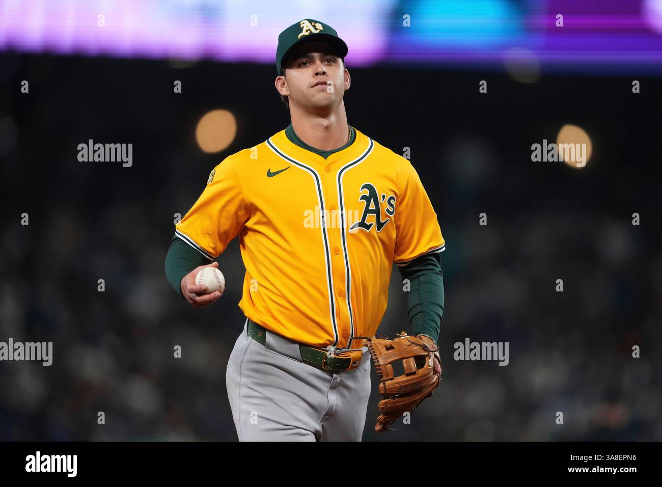Athletics second baseman Max Muncy jogs off the field during an opening ...