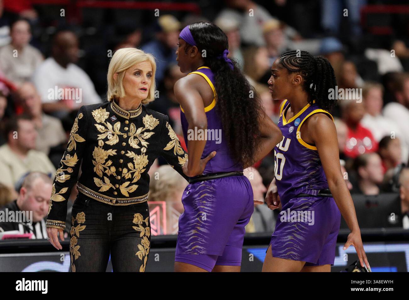 LSU head coach Kim Mulkey, left, speaks with guards Flau'Jae Johnson ...