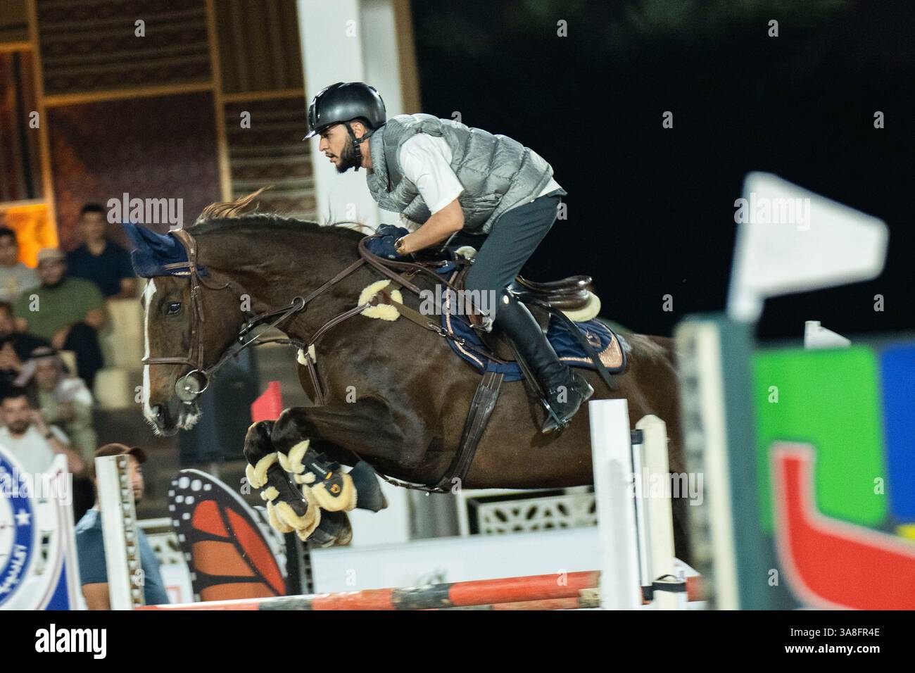 Mohammad Moften on his horse competes in the Show Jumping Championship ...