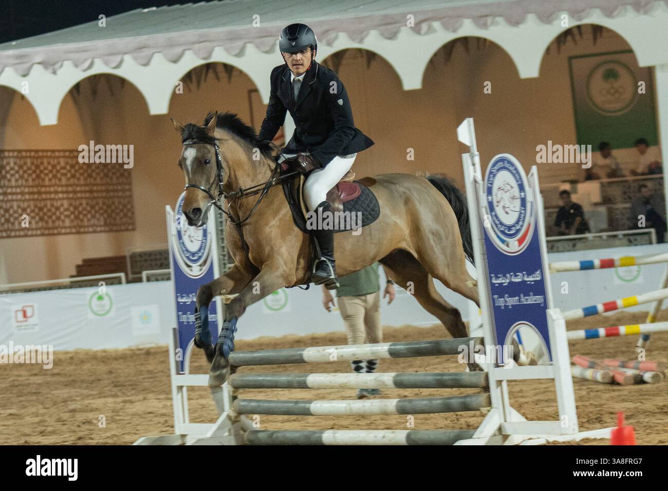 Mehdi Mohammed on his horse competes in the Show Jumping Championship ...