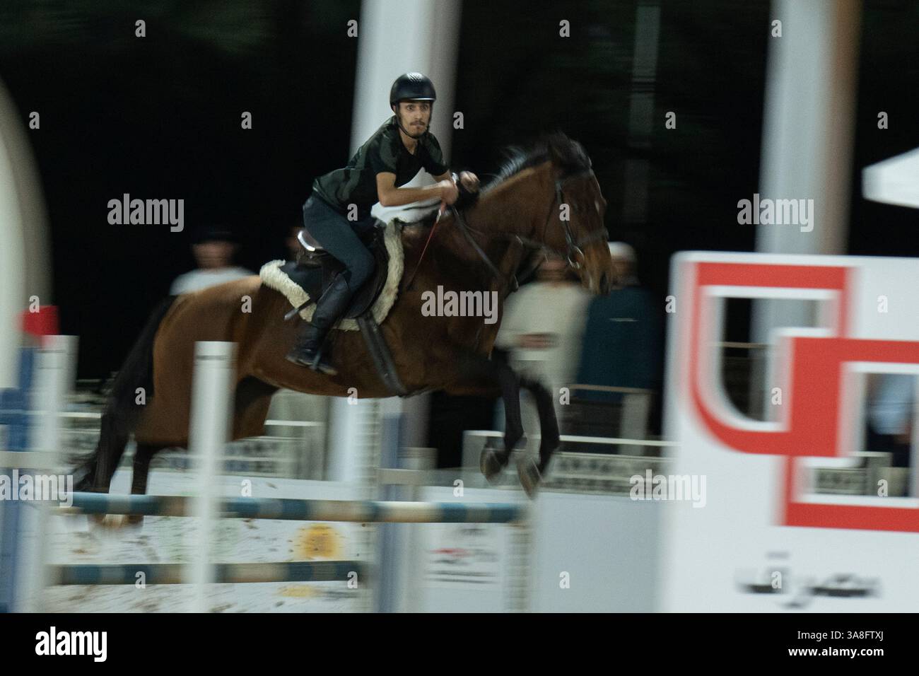 Hussein Loay on his horse competes in the Show Jumping Championship at ...