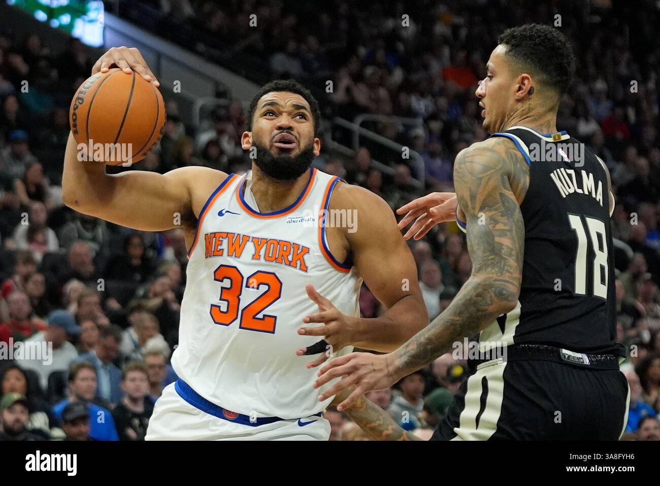 New York Knicks' Karl-Anthony Towns (32) drives to the basket against Milwaukee Bucks' Kyle ...