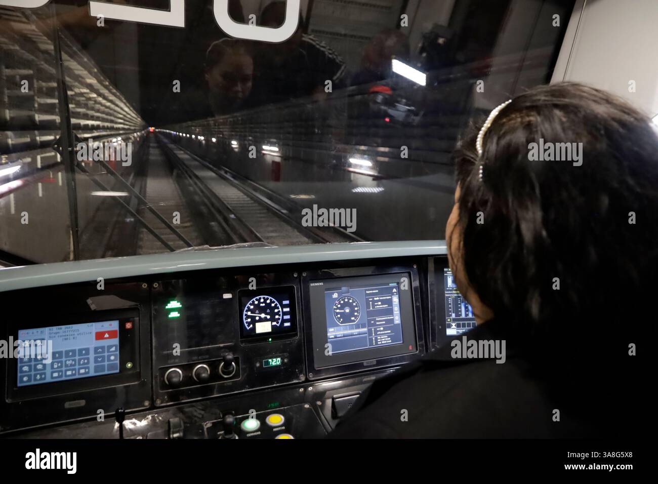 A woman’s driver of Mexico City Metro, controls the cabin of a metro ...