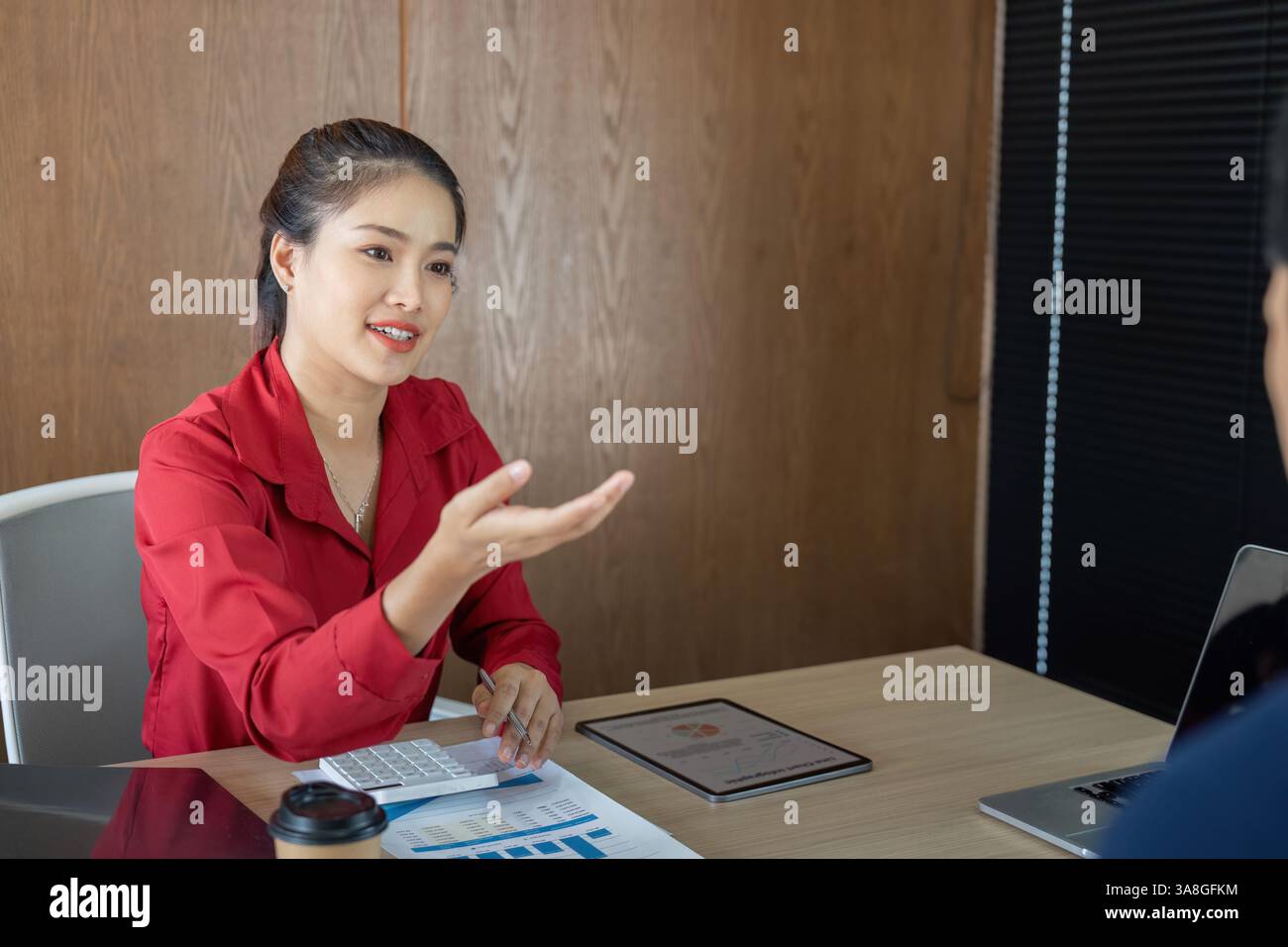 Financial Consultation and Interaction. Engaging in a detailed financial overview in an office ...