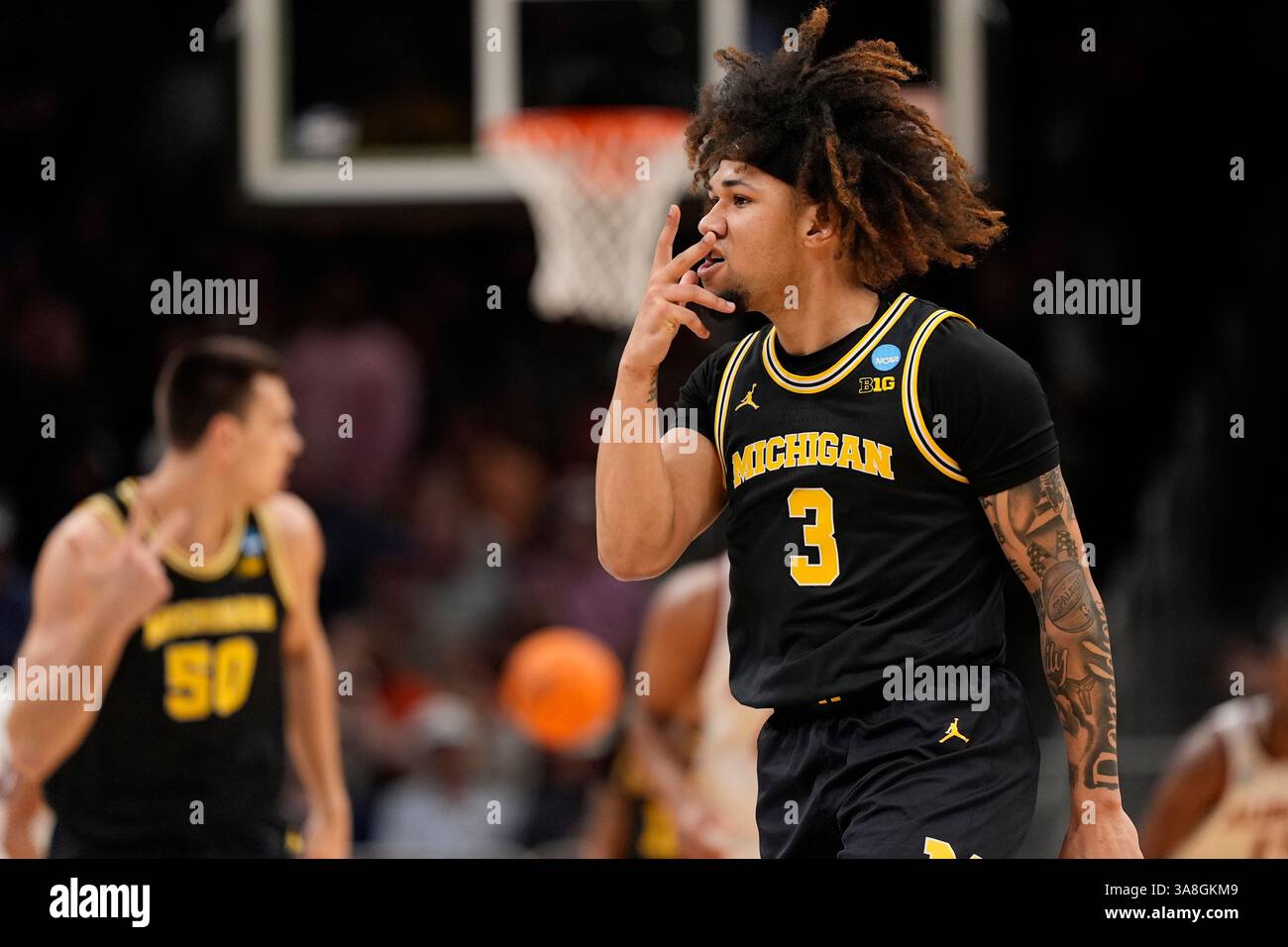 Michigan guard Tre Donaldson (3) reacts to a three-point shot against ...