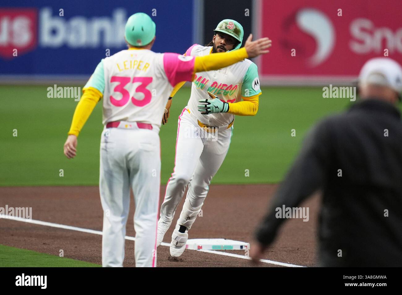 San Diego Padres' Fernando Tatis Jr., center, celebrates with third ...