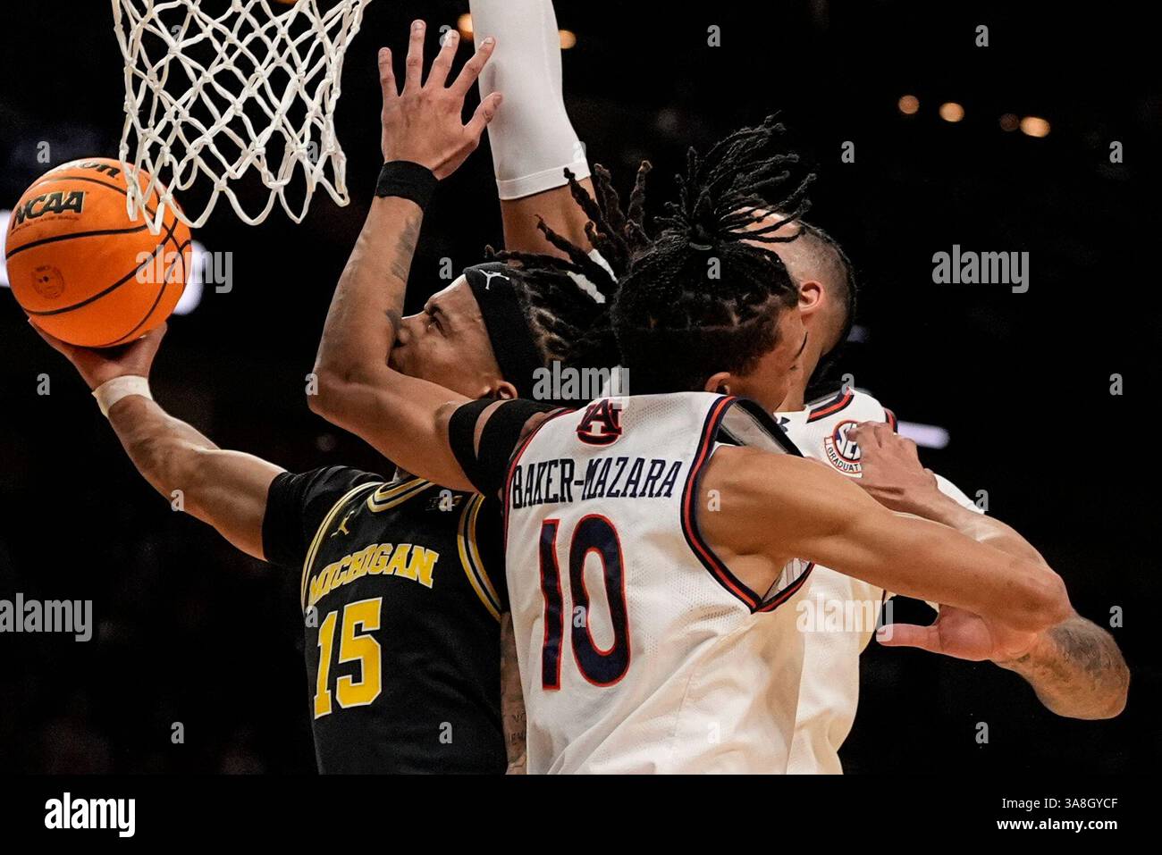 Michigan guard Rubin Jones (15) drives against Auburn guard Chad Baker ...