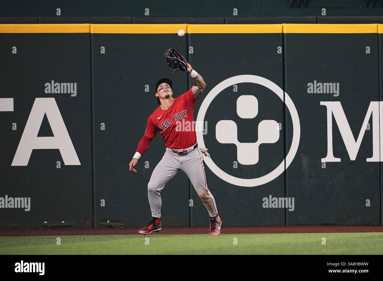 Boston Red Sox left fielder Jarren Duran reaches up to catch a fly out ...