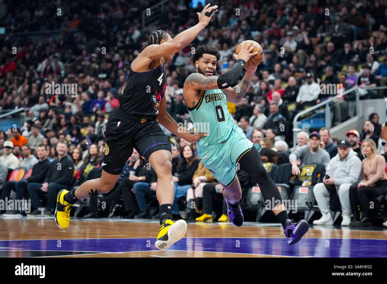 Toronto Raptors forward Scottie Barnes (4) attempts to guard Charlotte Hornets forward Miles ...