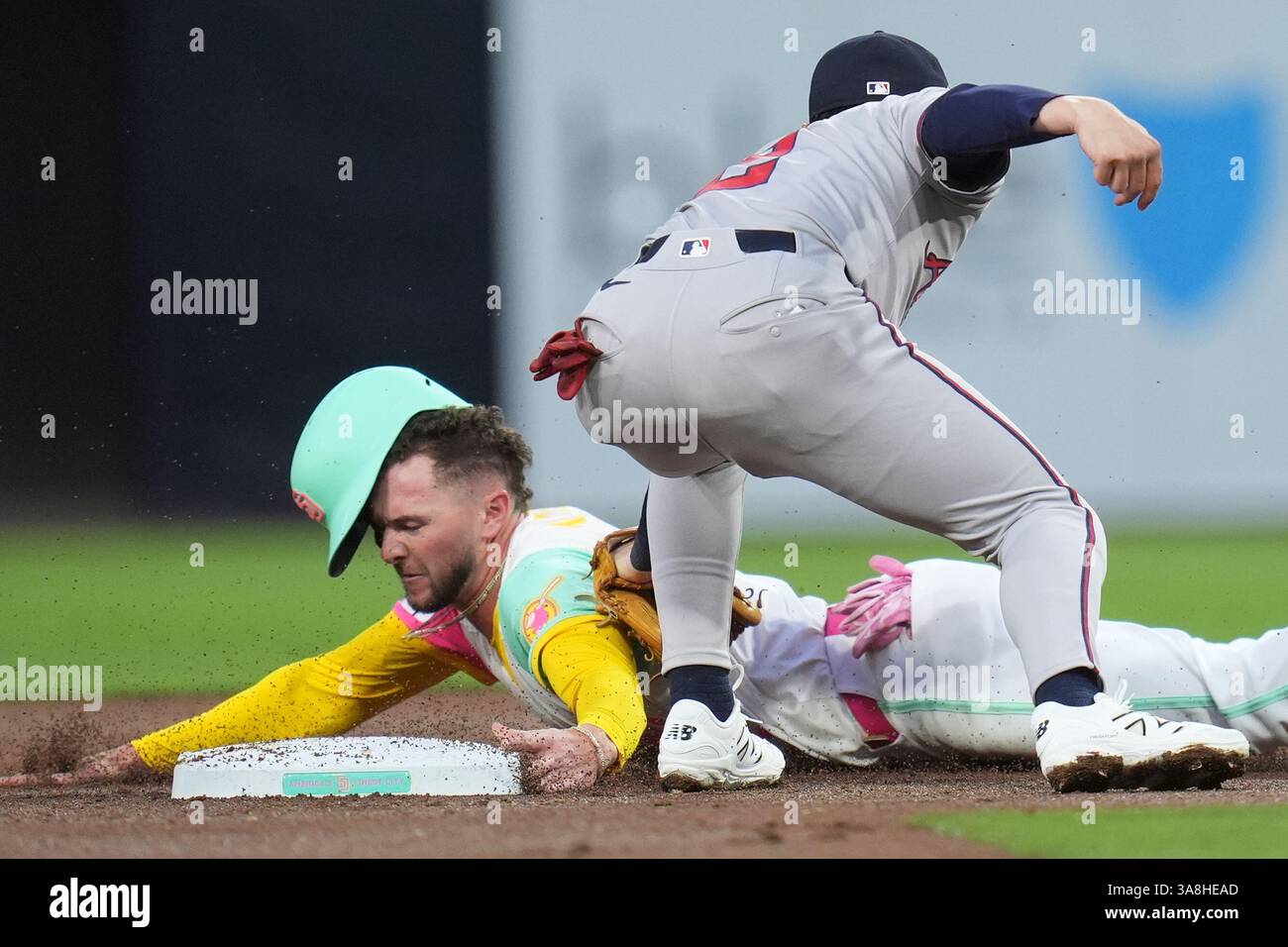 San Diego Padres' Jackson Merrill, below, is tagged out by Atlanta ...