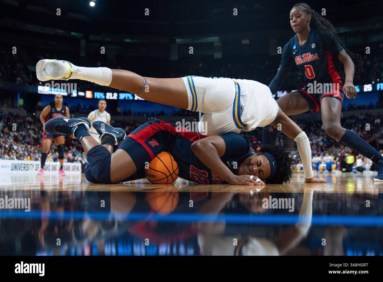 UCLA forward Janiah Barker dives over Mississippi forward Christeen ...