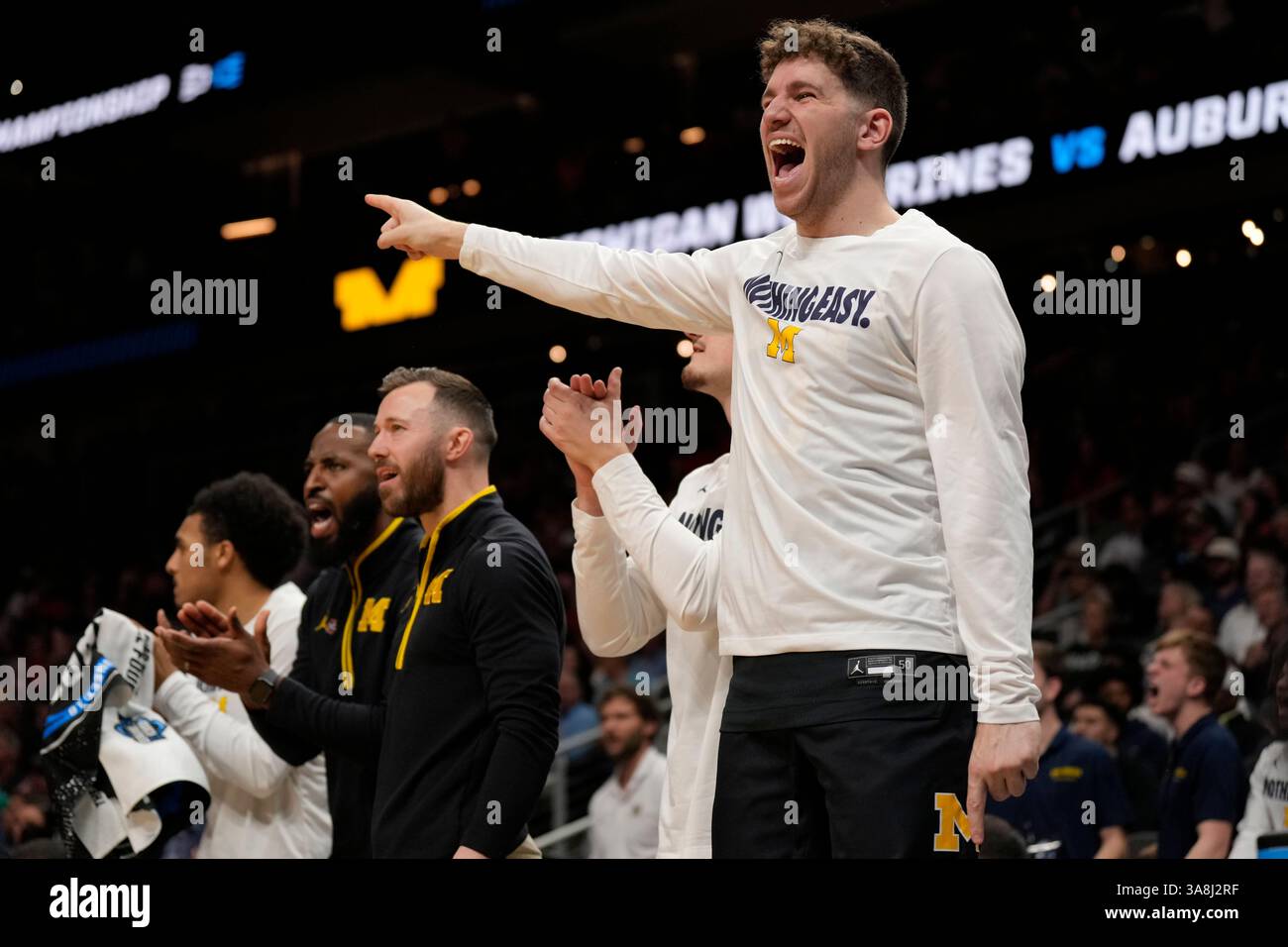 The Michigan bench celebrates play against Auburn during the second ...
