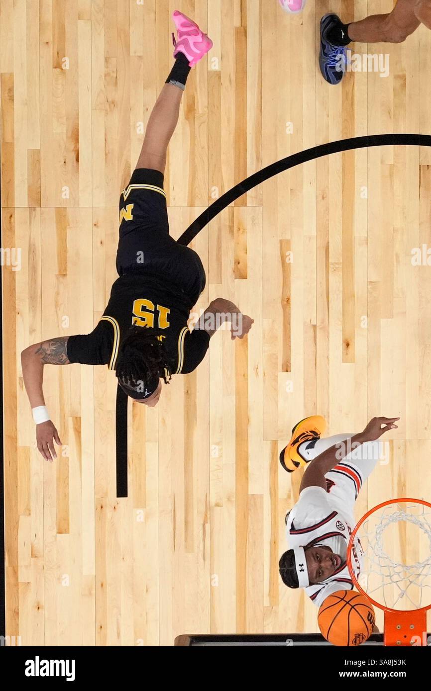 Auburn guard Denver Jones (2) shoots against Michigan guard Rubin Jones ...